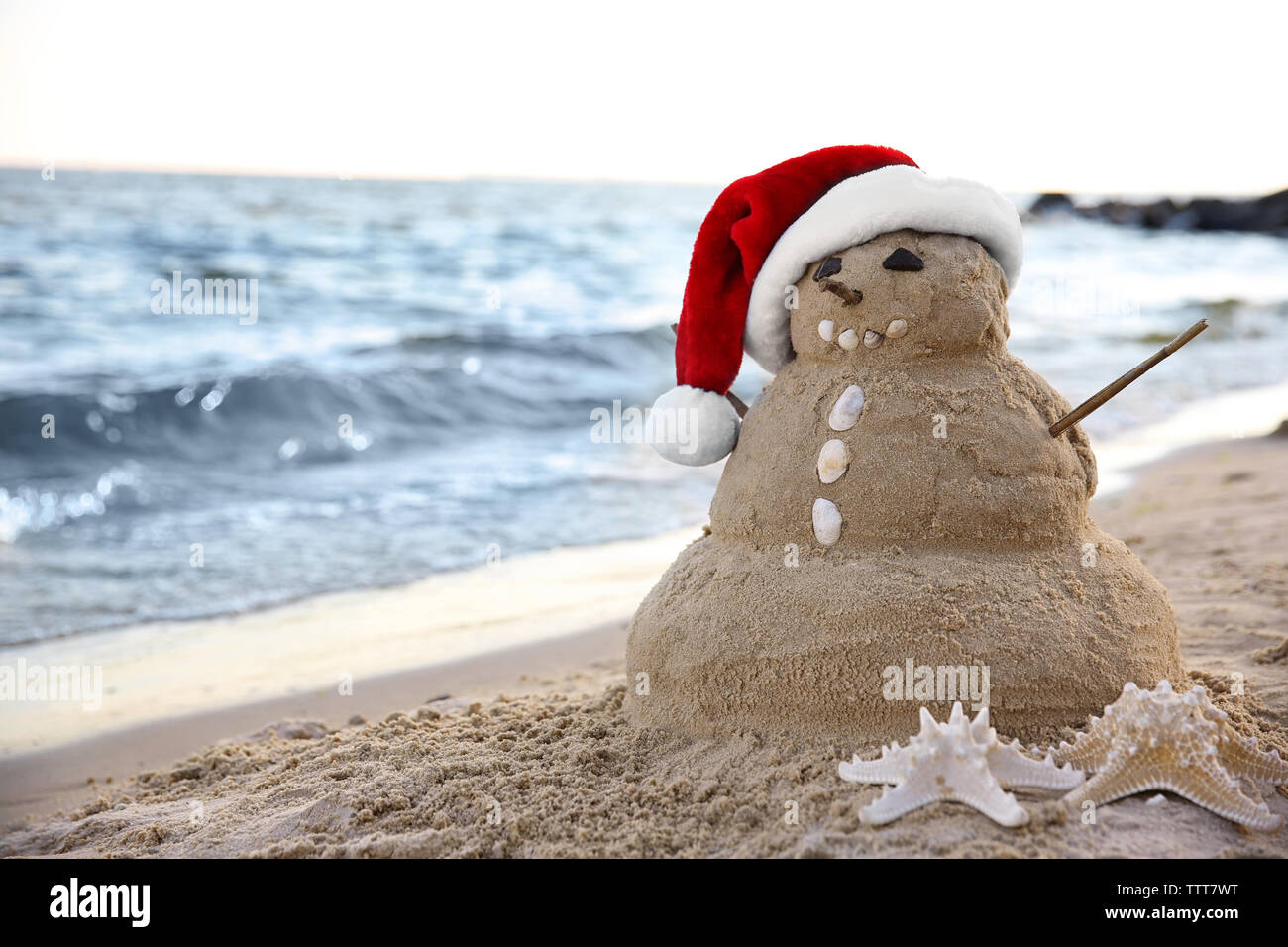 Snowman made of sand on beach. Christmas holiday concept Stock Photo ...