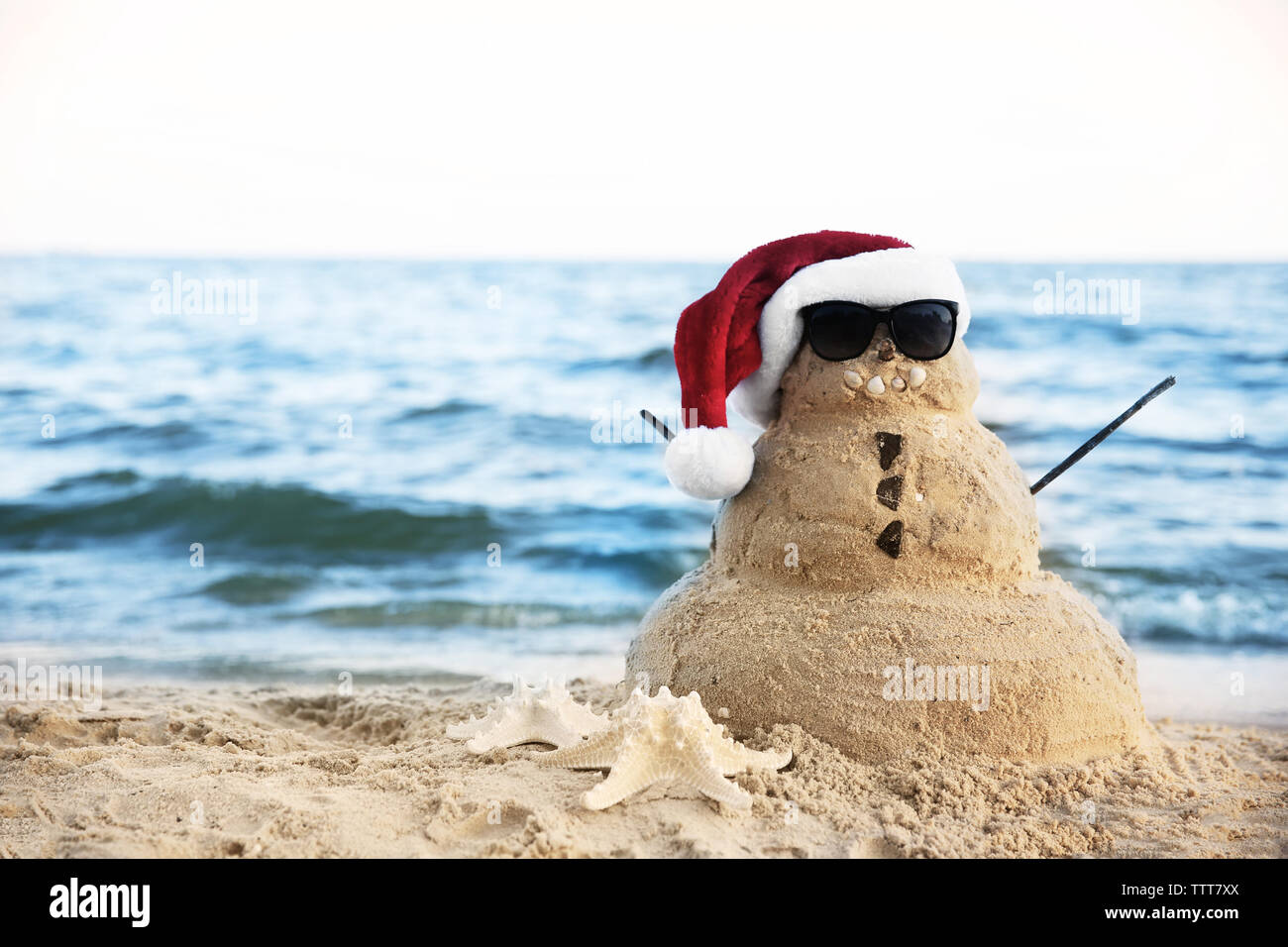 Snowman made of sand on beach. Christmas holiday concept Stock Photo ...