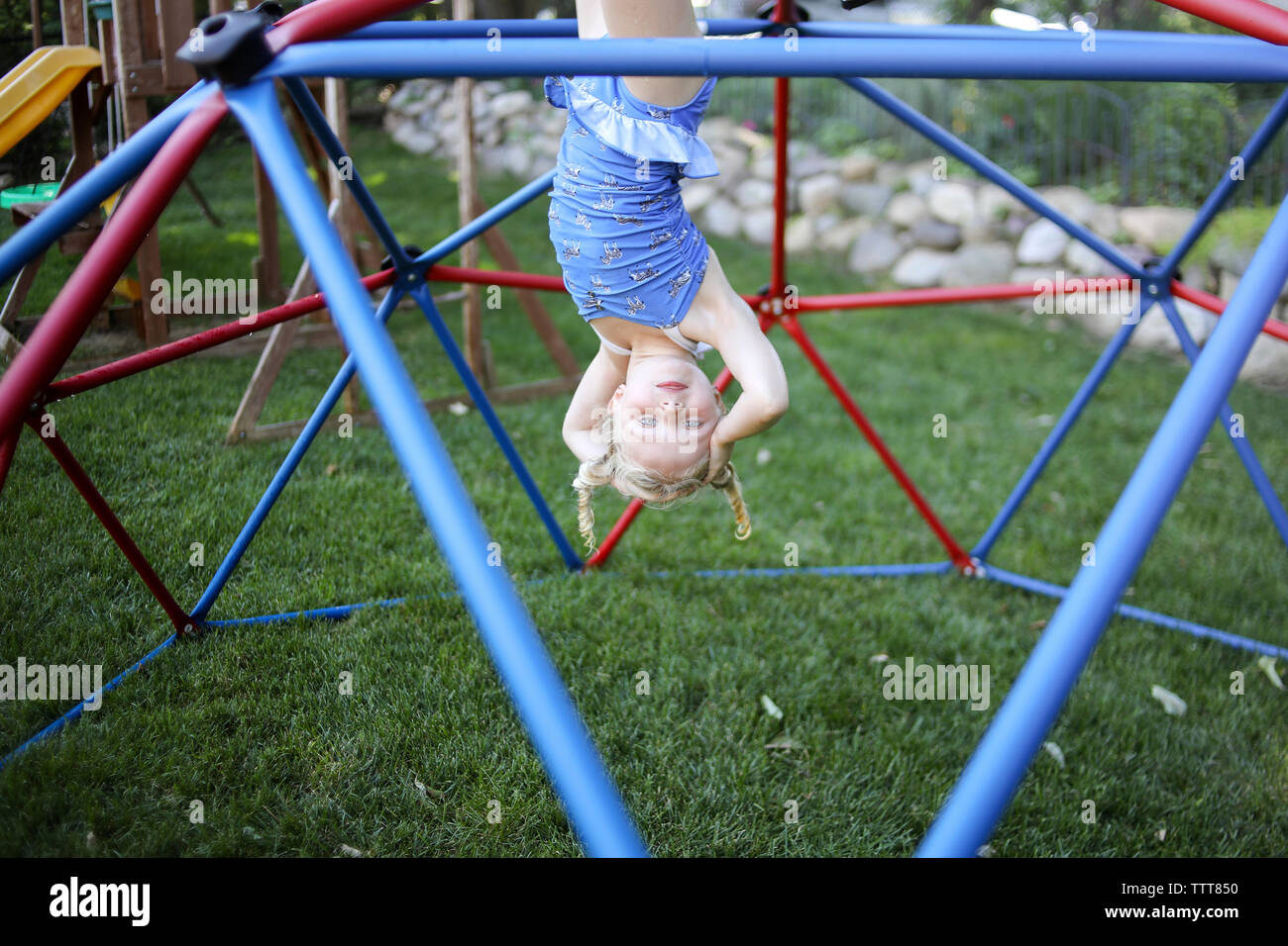 Girl playing playground upside down hi-res stock photography and images - Alamy