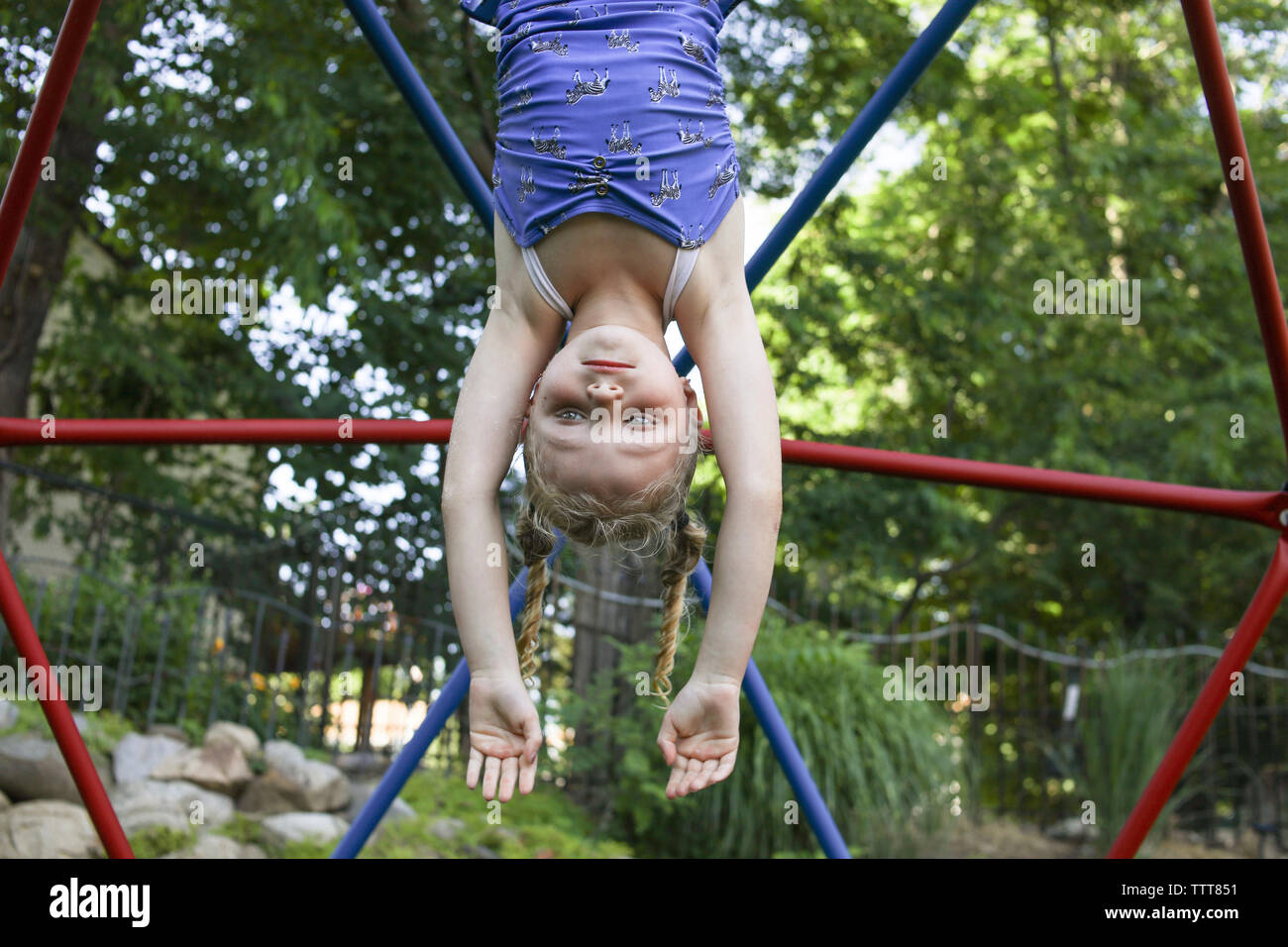 Girl playing playground upside down hi-res stock photography and images - Alamy