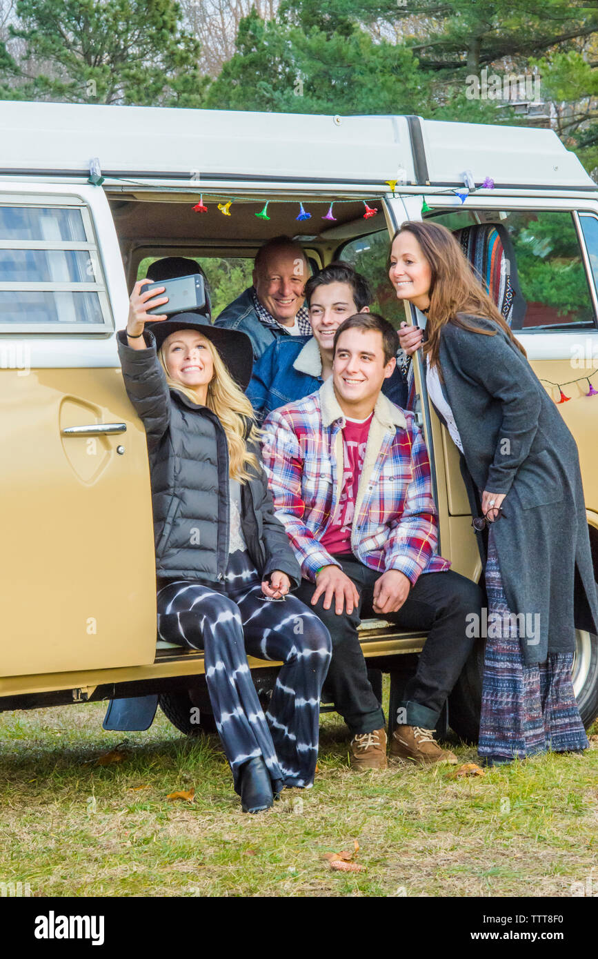 Happy family taking selfie at doorway of van Stock Photo - Alamy