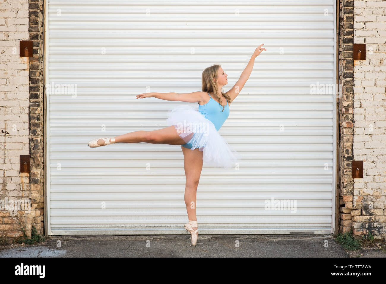 Side view of girl jumping in puddle at footpath Stock Photo - Alamy