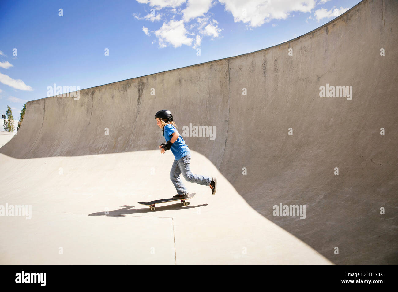 Side view of boy skateboarding on ramp Stock Photo - Alamy
