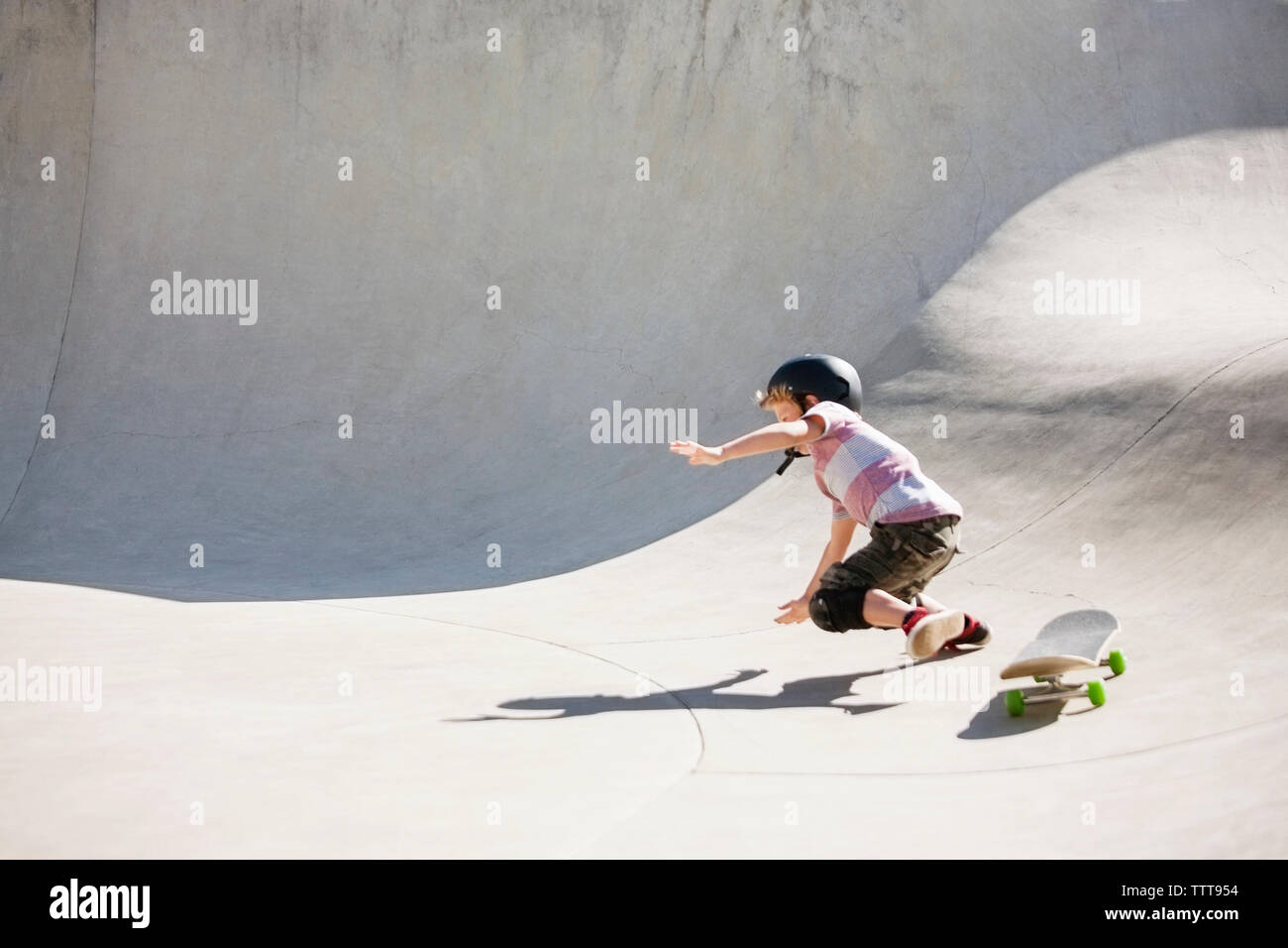 Boy falling on skateboard ramp Stock Photo - Alamy