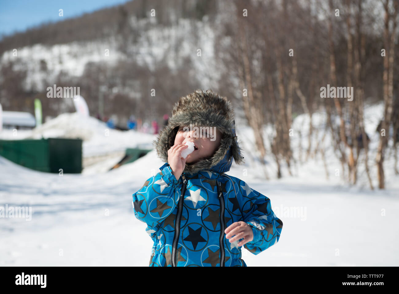 Boy eating snow Stock Photo - Alamy