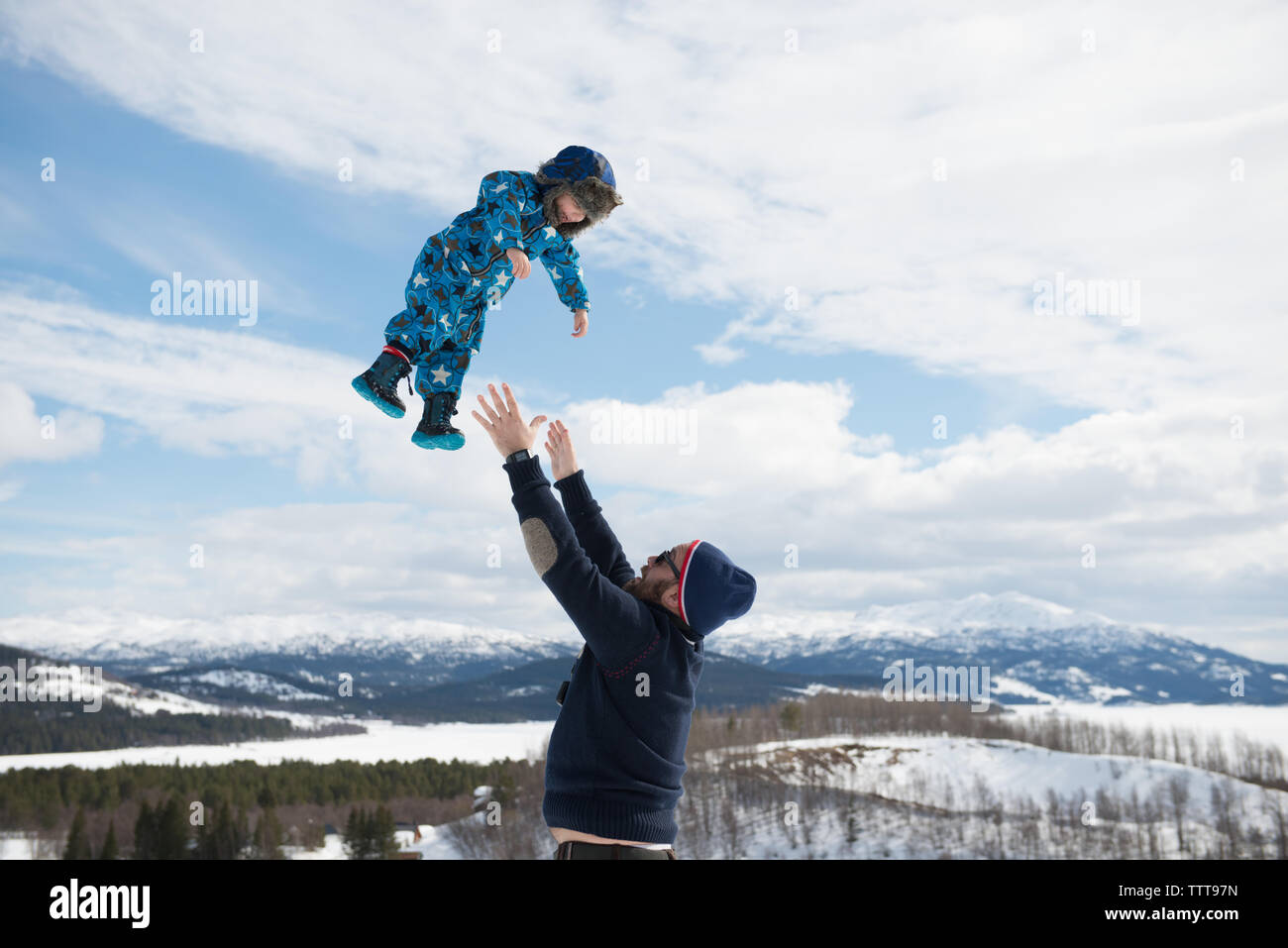 Father son playing in snowy mountain in winter wonderland Stock Photo ...