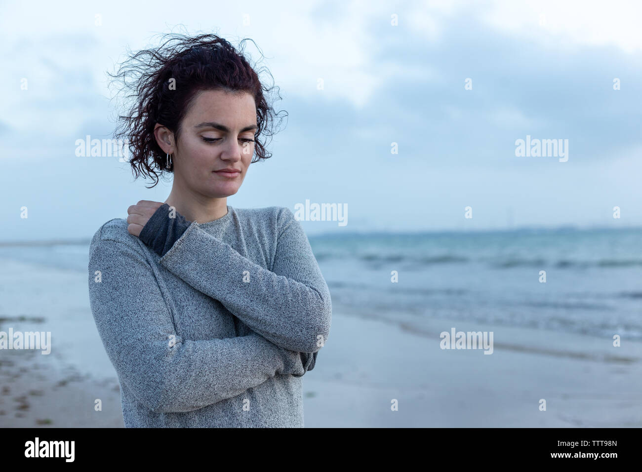 Woman hugging herself sad hi-res stock photography and images - Alamy
