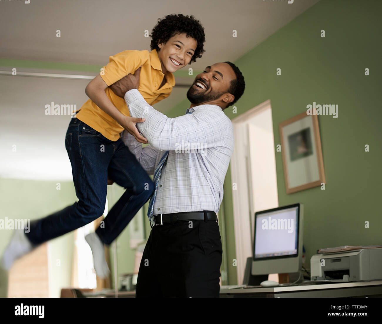 Happy father carrying son at home Stock Photo - Alamy