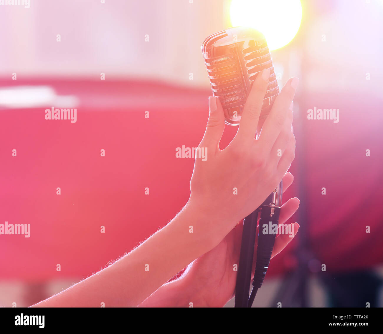 Female hands holding retro microphone, close up Stock Photo - Alamy