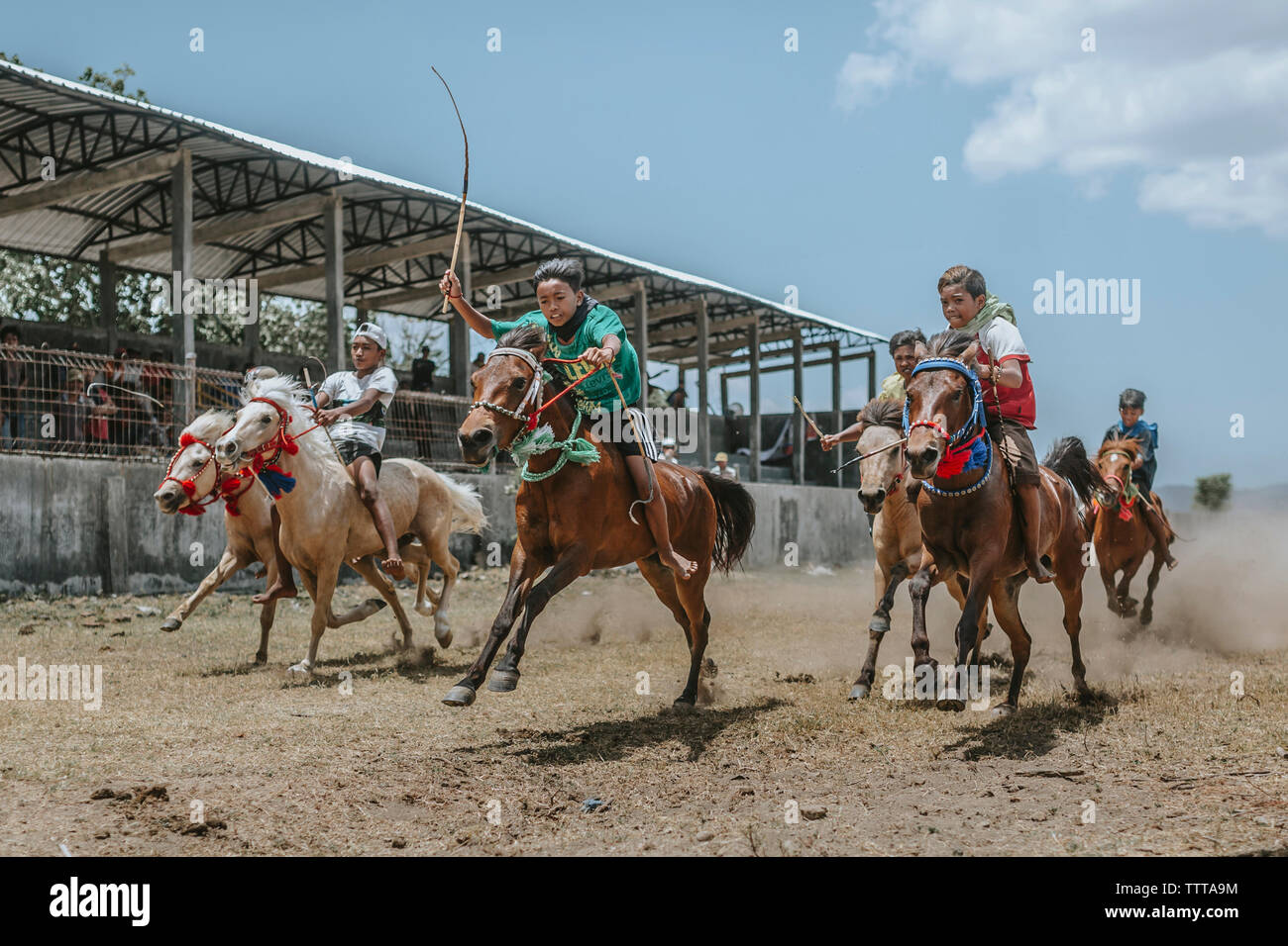 Children riding racehorses during horse racing Stock Photo - Alamy