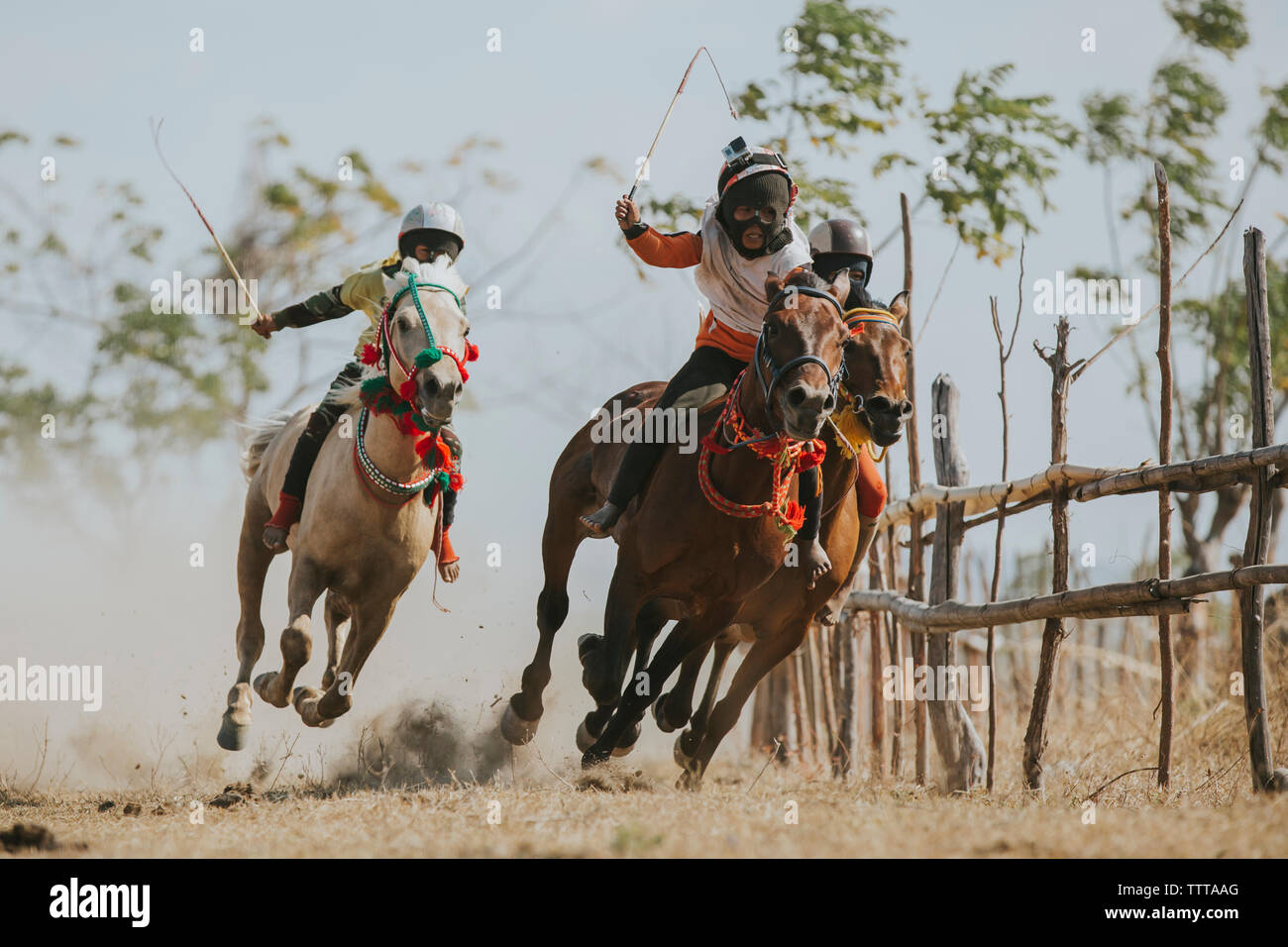 Child Jockeys riding racehorses on field during horse racing Stock ...