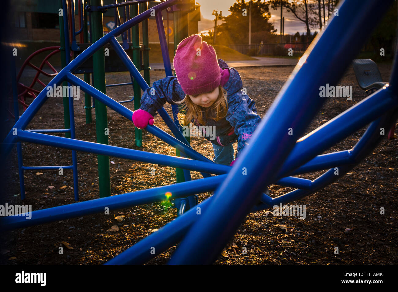 toddler girl playing at playground at fall during sunset Stock Photo ...