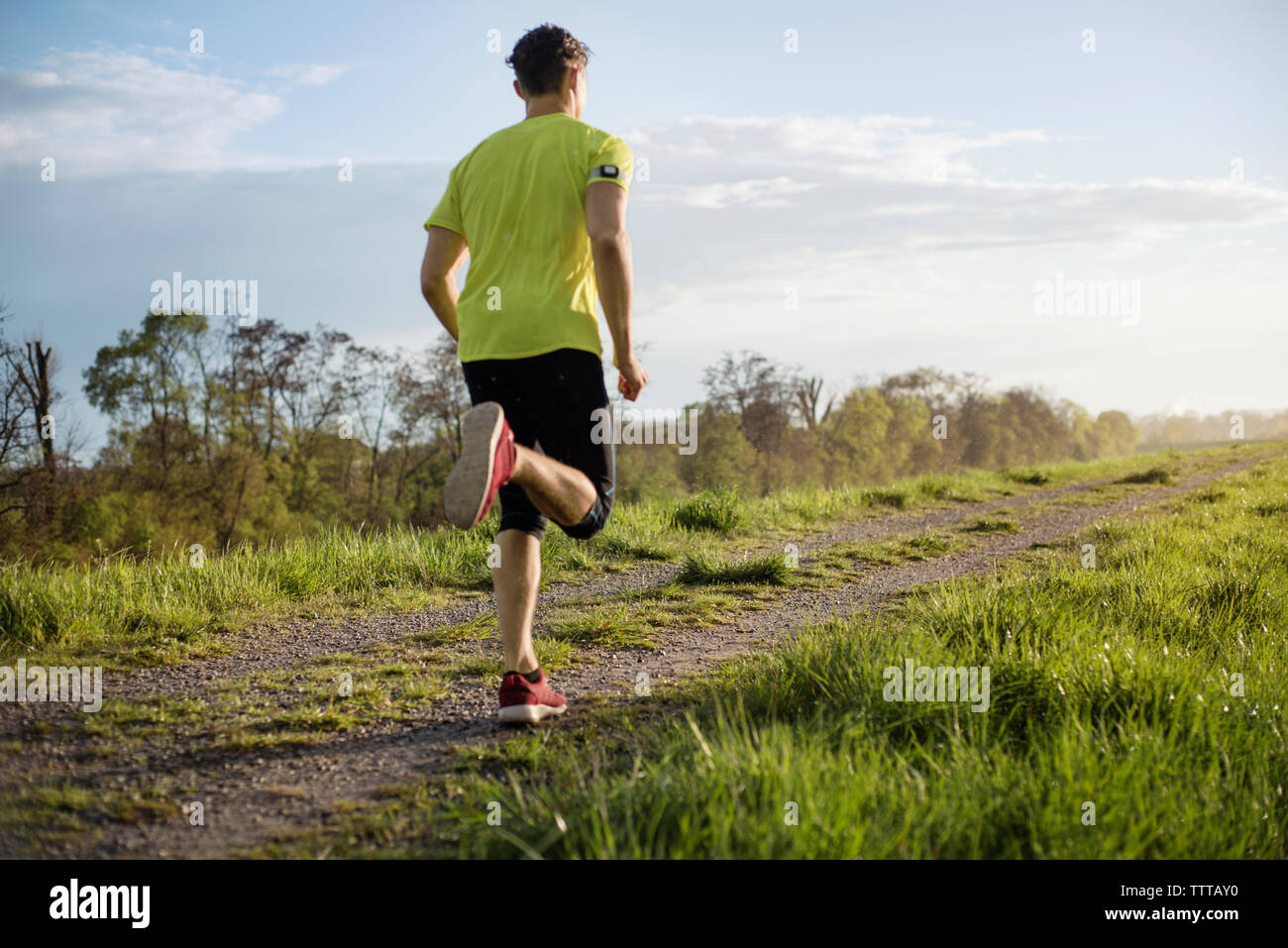 Rear view of a male athlete running up staircase outside building Stock ...