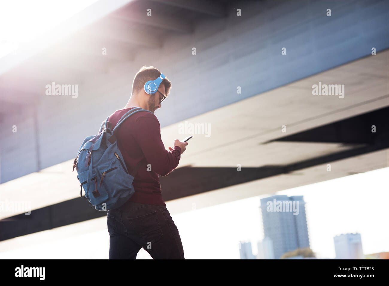 Young man walking listening music hi-res stock photography and images ...
