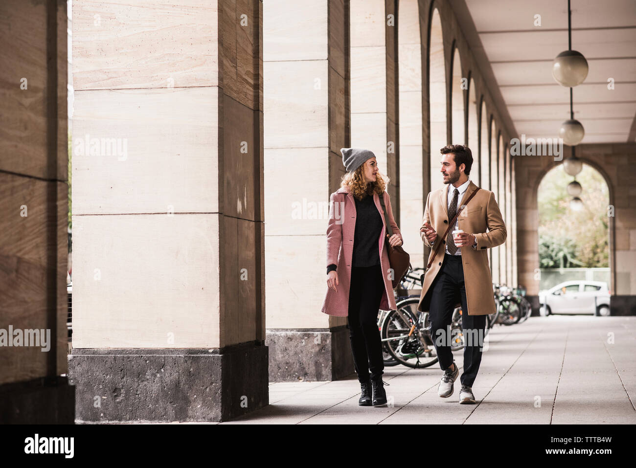 Colleagues talking in corridor hi-res stock photography and images - Alamy