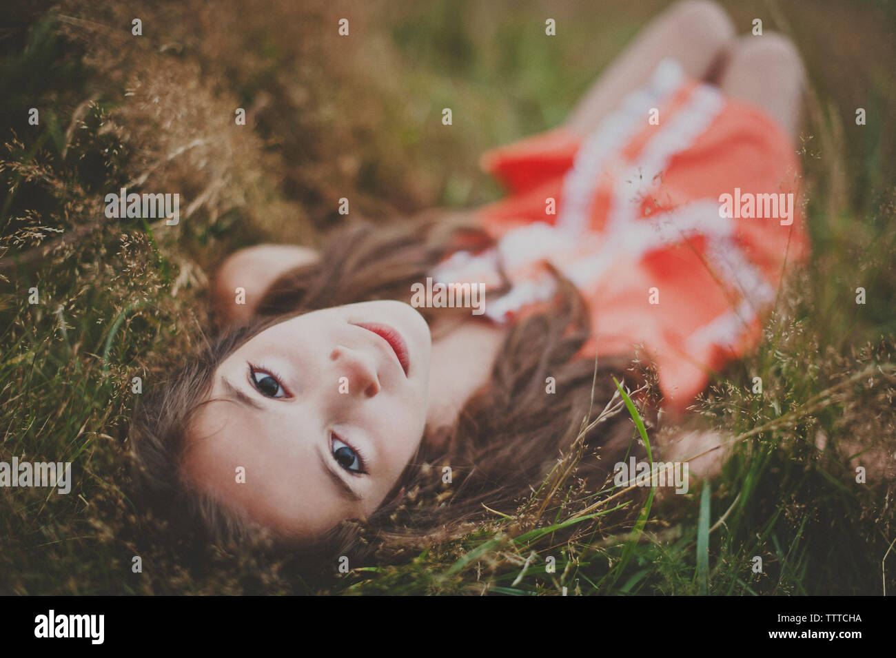 High angle portrait of girl lying on field Stock Photo - Alamy