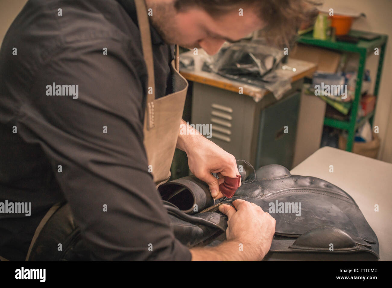 Side view of shoemaker making shoes at workshop Stock Photo - Alamy