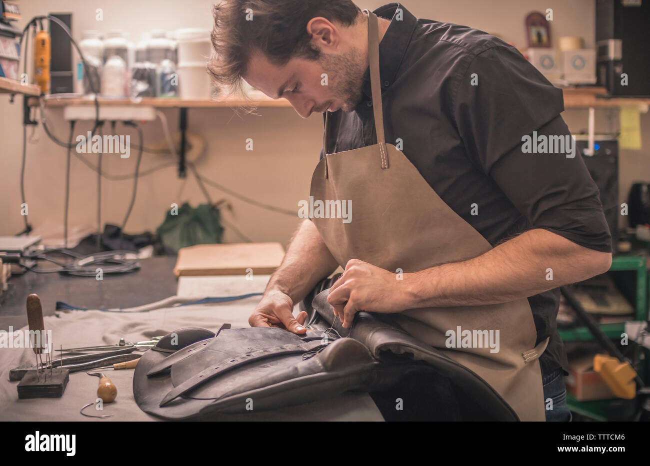 Side view of male shoemaker making shoes at workshop Stock Photo - Alamy