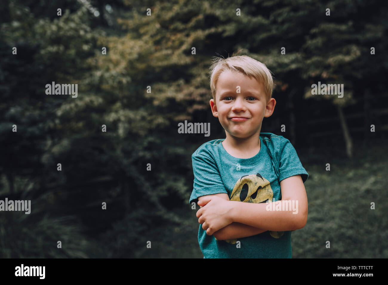 Boy with crossed arms hi-res stock photography and images - Alamy