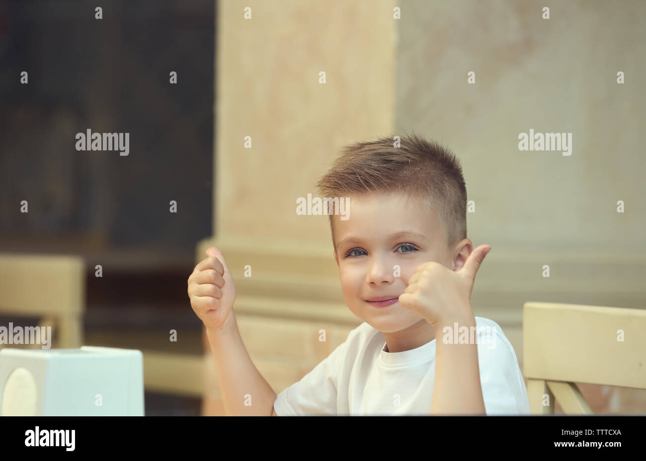 Cute boy in restaurant Stock Photo - Alamy