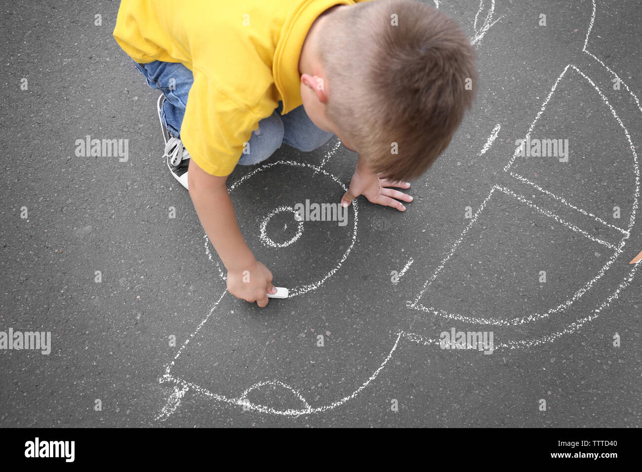 Boy with chalk drawing car Stock Photo - Alamy