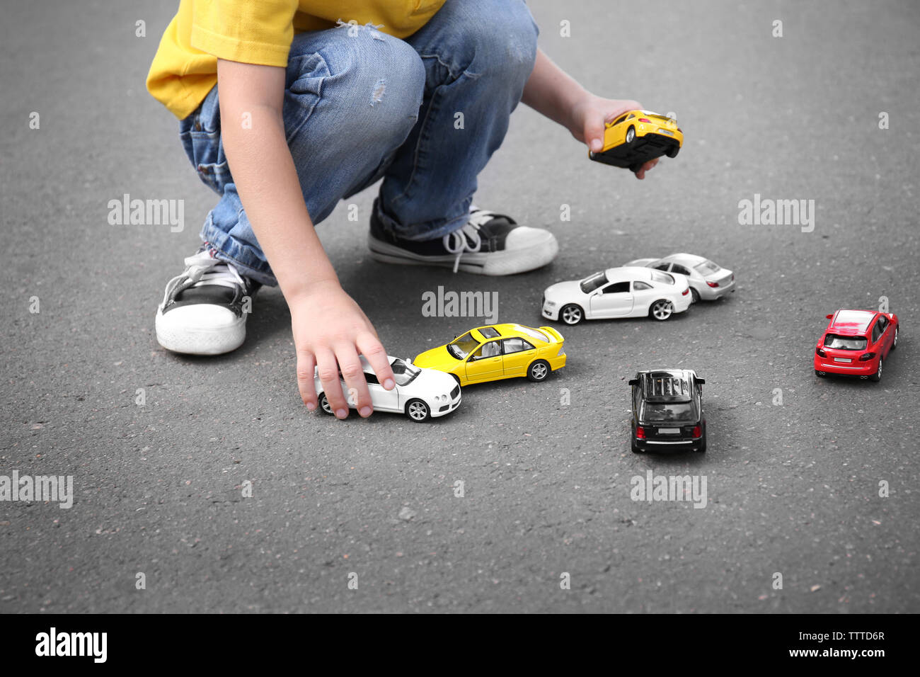 Little boy playing with toy cars outdoor Stock Photo - Alamy