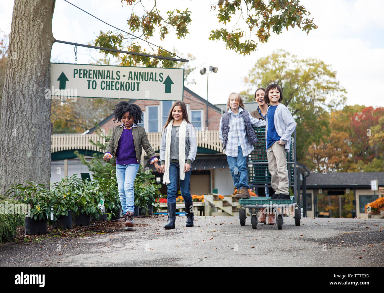 Happy teacher with students on road during field trip Stock Photo - Alamy