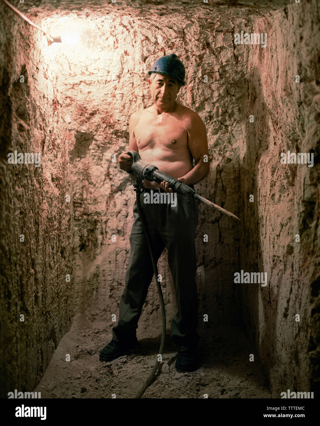 AUSTRALIA, Coober Pedy, the Outback, Opal miner with a drill equipment ...