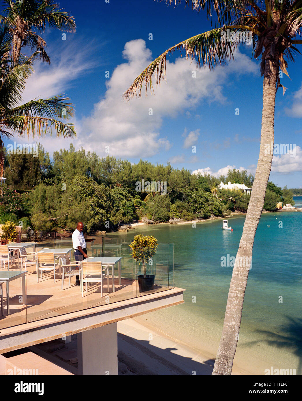 BERMUDA, Cambridge Resort, a waiter getting a table ready for lunch ...