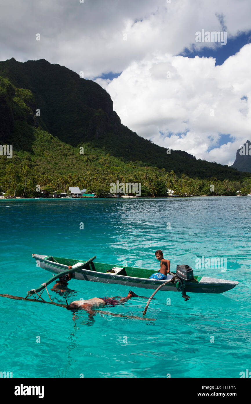 FRENCH POLYNESIA, Moorea Island. A family spearfishing at Opunohu Bay ...