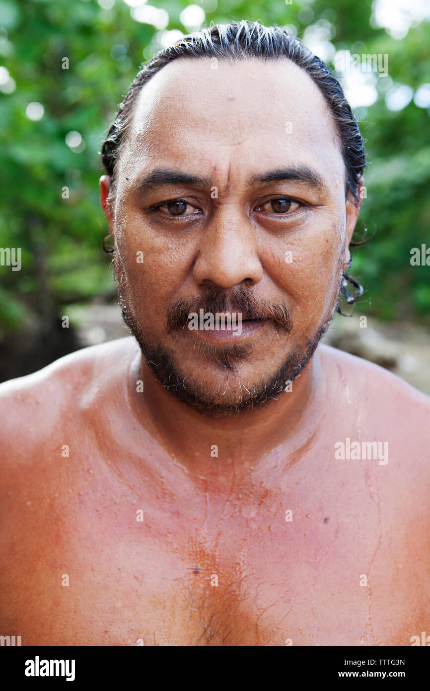 FRENCH POLYNESIA, Moorea. Portrait of man after swimming in the ocean ...
