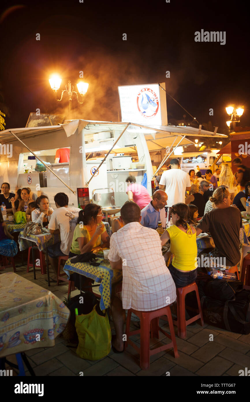 FRENCH POLYNESIA, Tahiti. Roulotte Food Trucks at night at the dock in ...