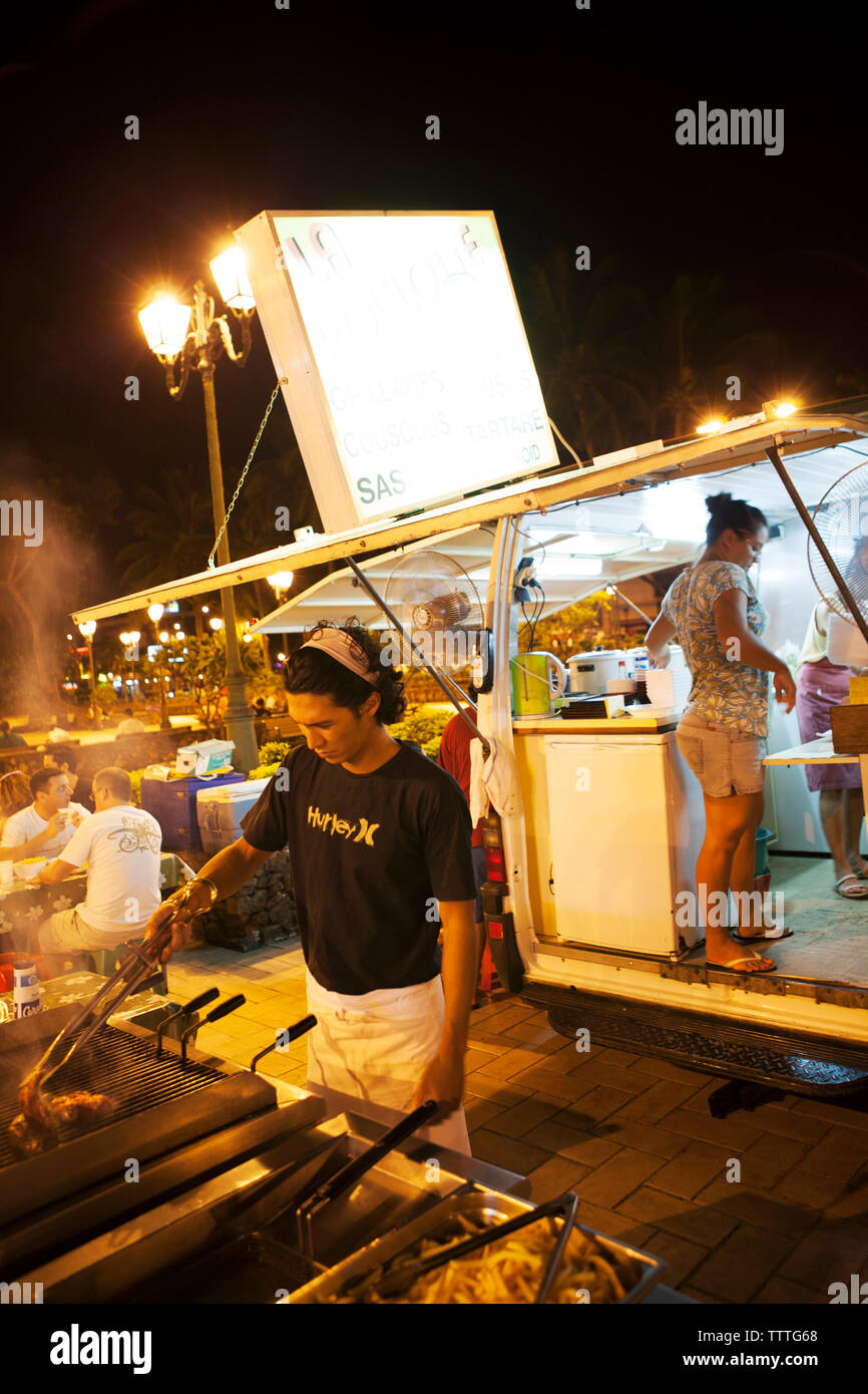 FRENCH POLYNESIA, Tahiti. Roulotte Food Trucks at night at the dock in ...