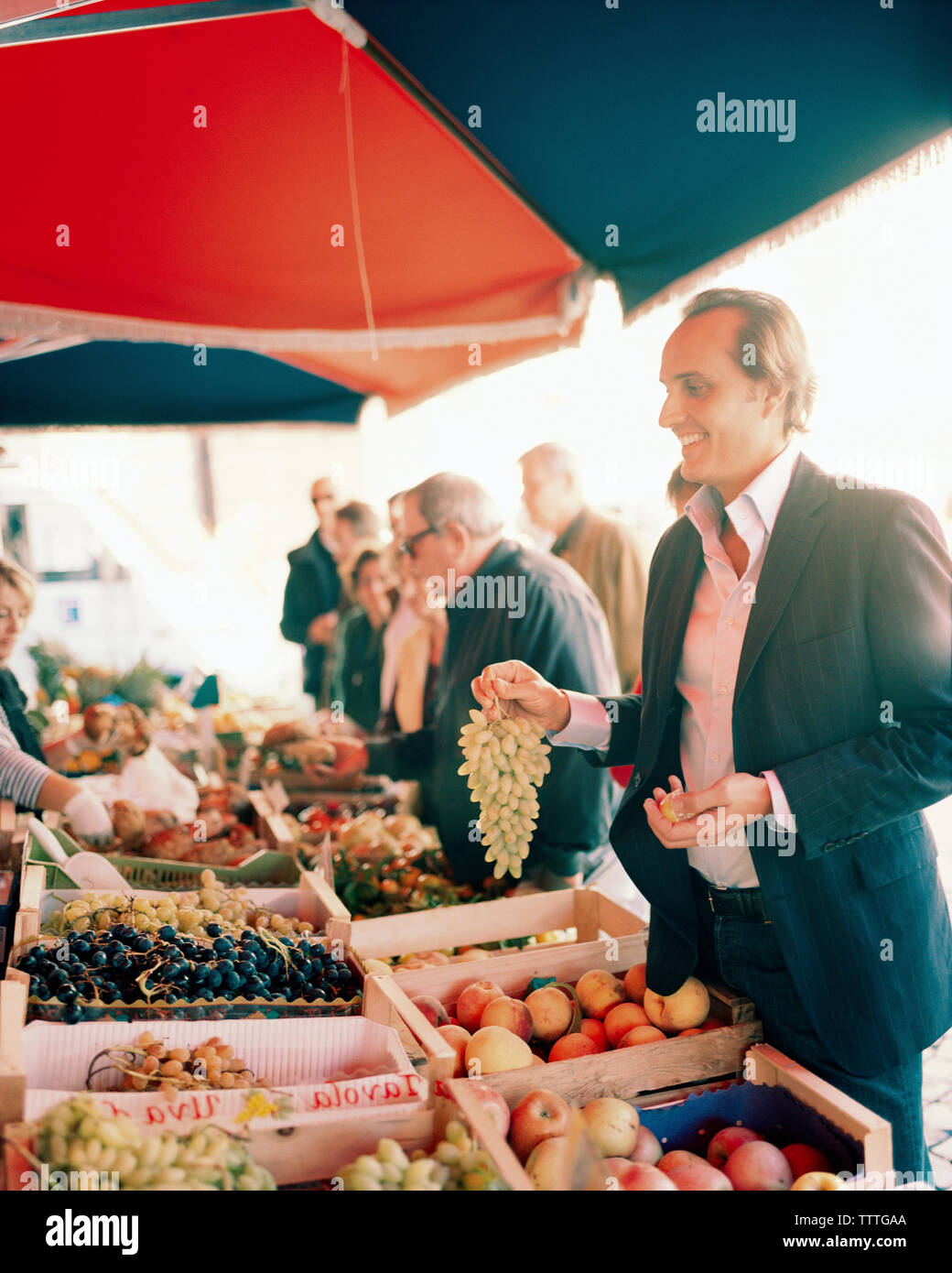 ITALY, Orvieto, Umbria, Chef Alex Palermo shopping for fruits at market ...