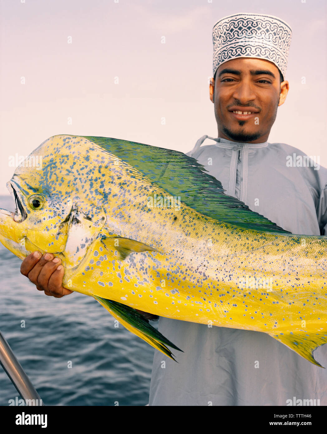 OMAN, Muscat, man holding mahi mahi fish, portrait Stock Photo - Alamy