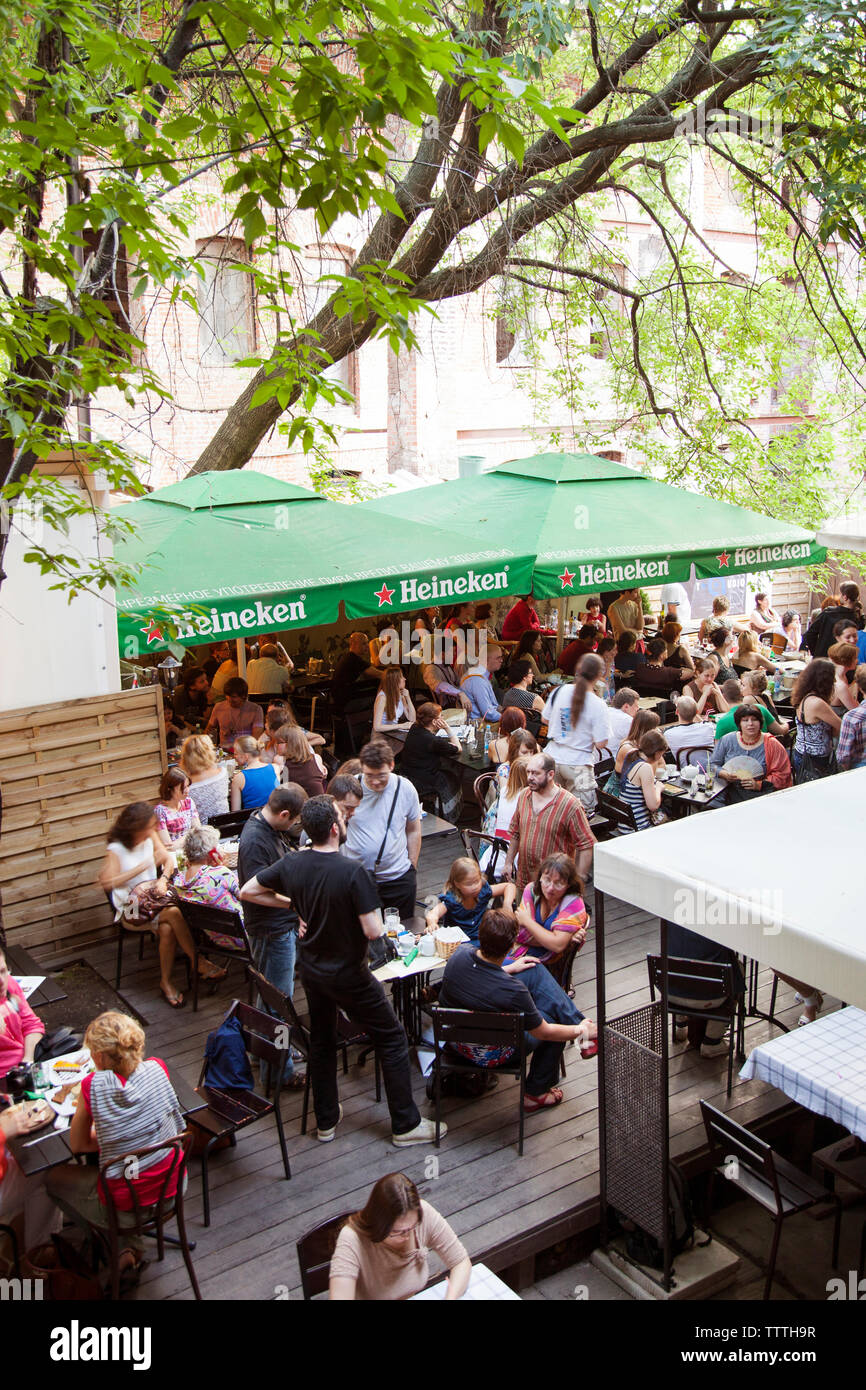 Crowd of people sitting outside restaurant bars hi-res stock ...