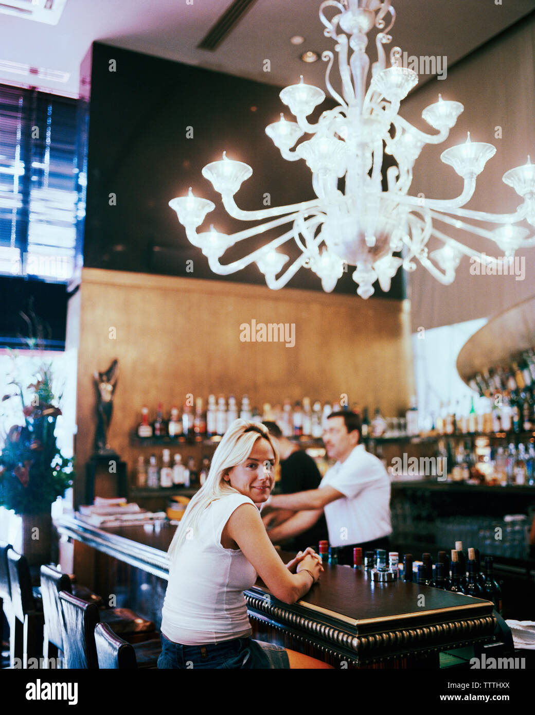 Woman sitting at a bar inside hi-res stock photography and images - Alamy