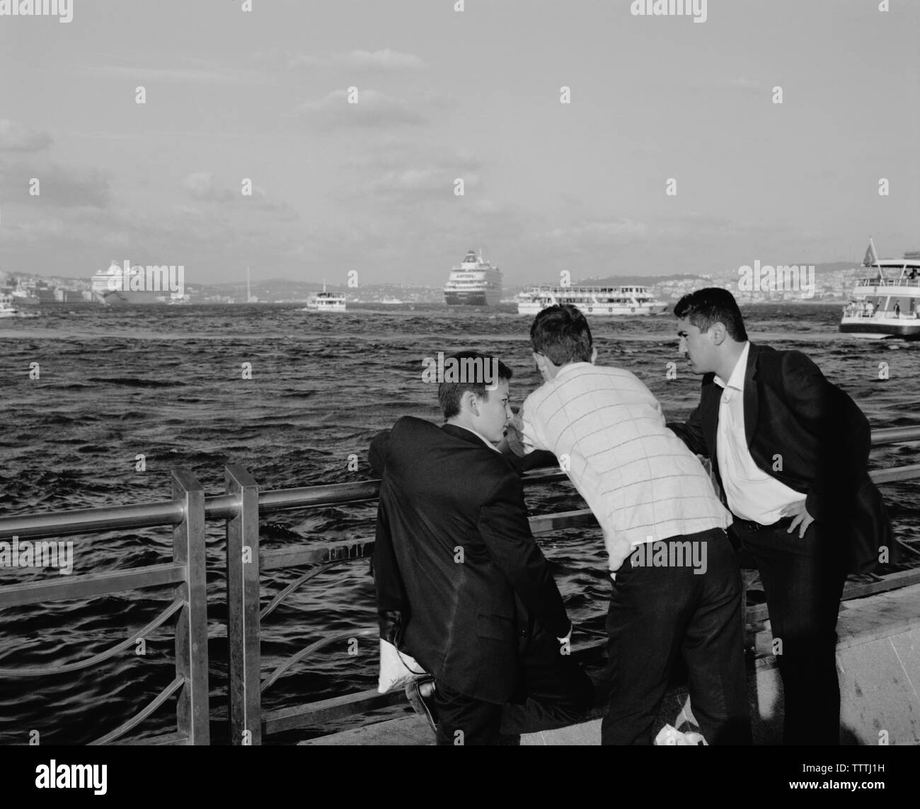 TURKEY, Istanbul, rear view of people waiting for the ferry (B&W Stock ...