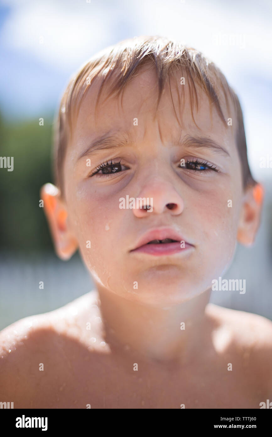 Boy with questioned expression is dripping wet from summer pool Stock ...
