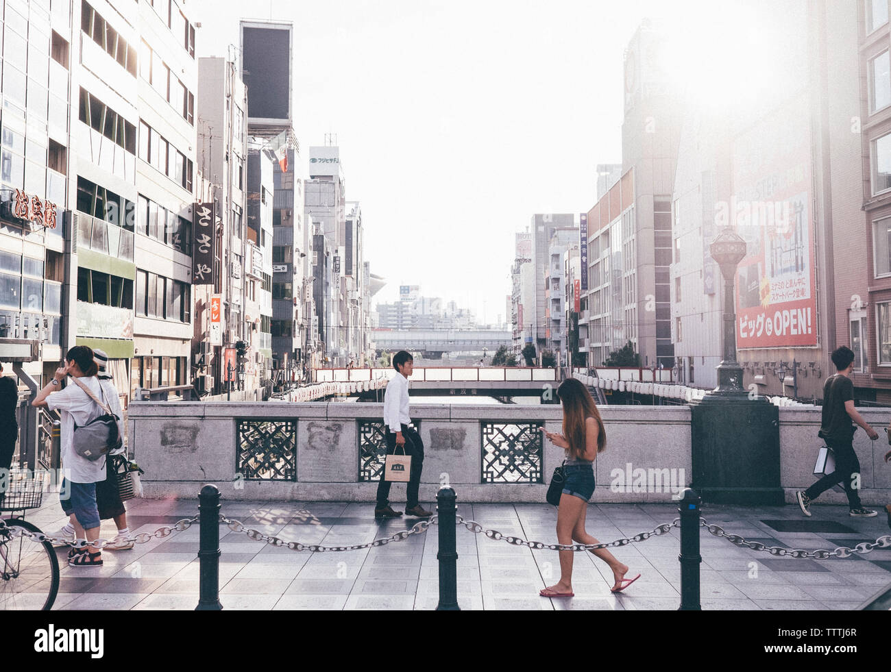 People walking on bridge in city Stock Photo - Alamy