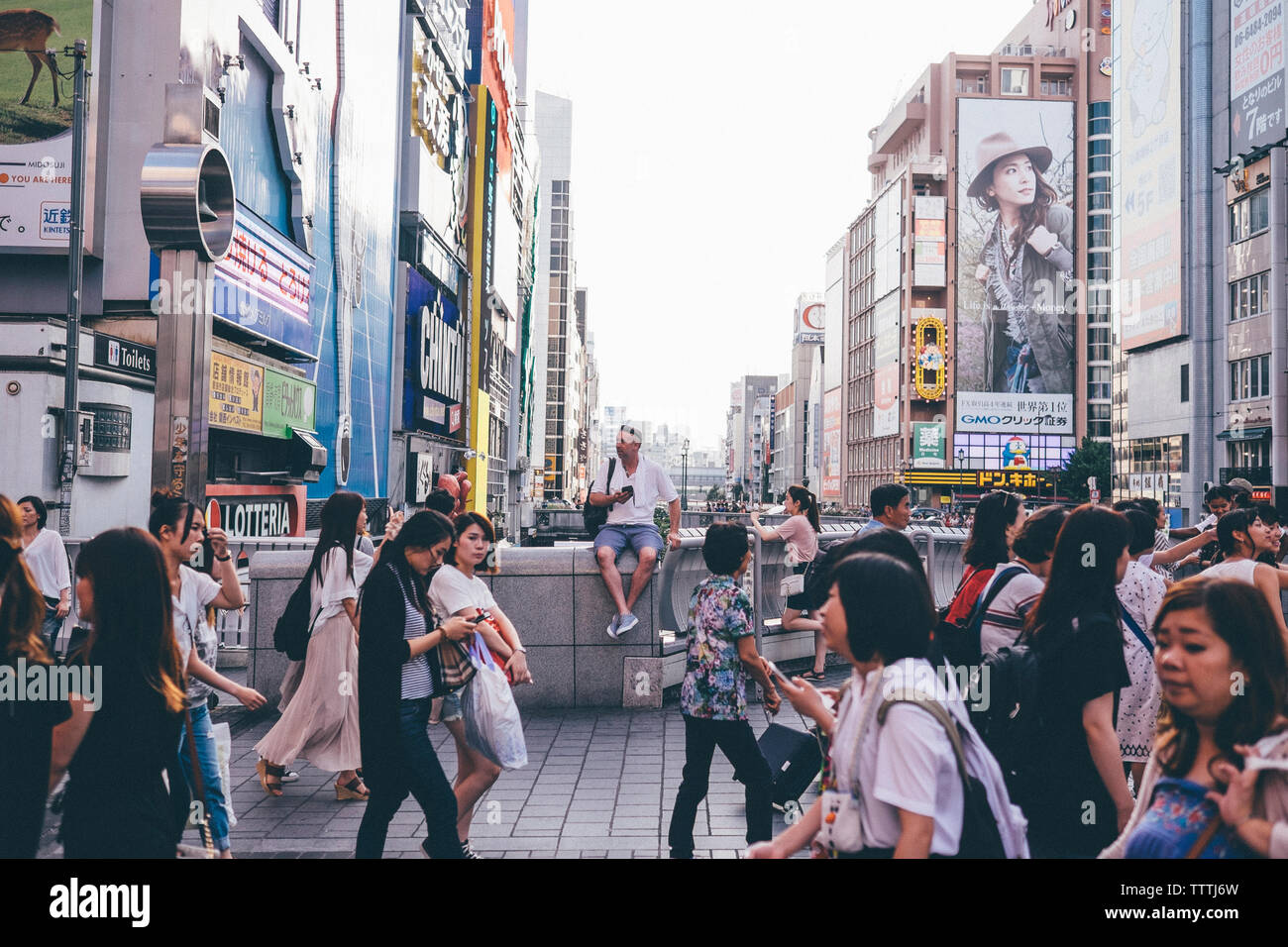 People on bridge against buildings in city Stock Photo - Alamy
