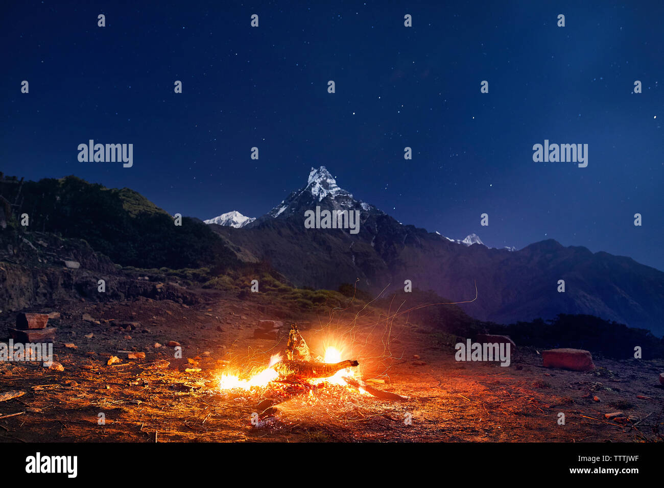 Campfire on mountain against blue sky at night Stock Photo - Alamy
