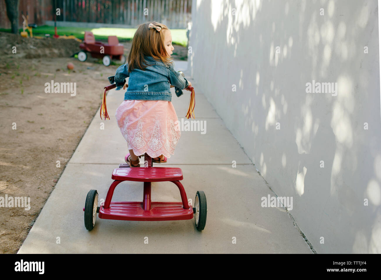 Girl riding tricycle hi-res stock photography and images - Alamy