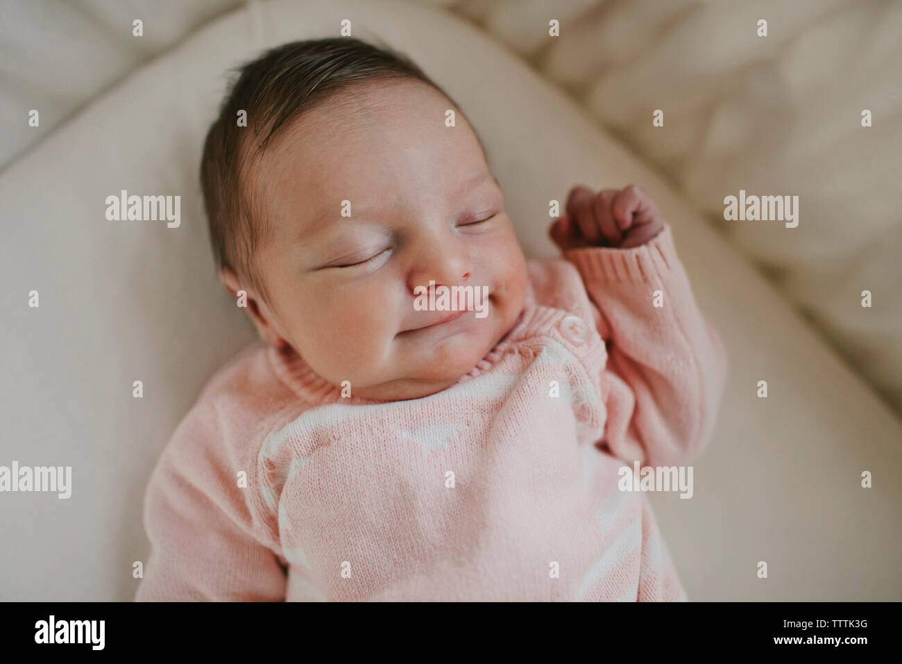 Overhead view of cute baby girl wearing sweater sleeping in crib Stock ...