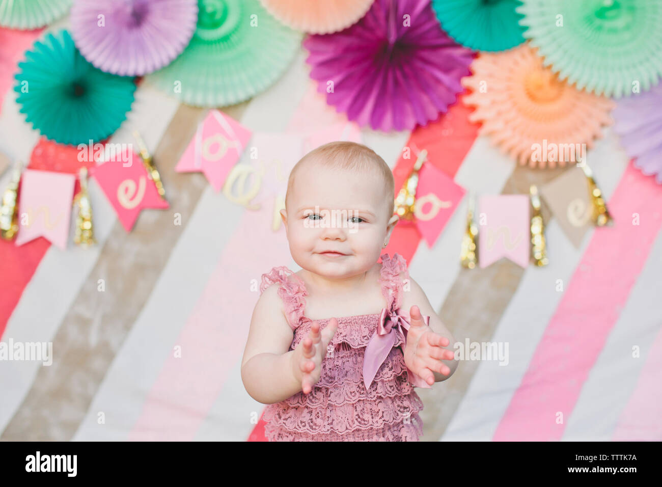 Portrait of cute baby girl clapping at birthday party Stock Photo - Alamy