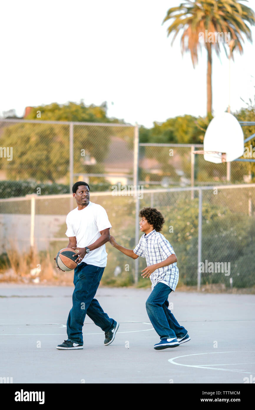 Father and son playing basketball at playground Stock Photo - Alamy