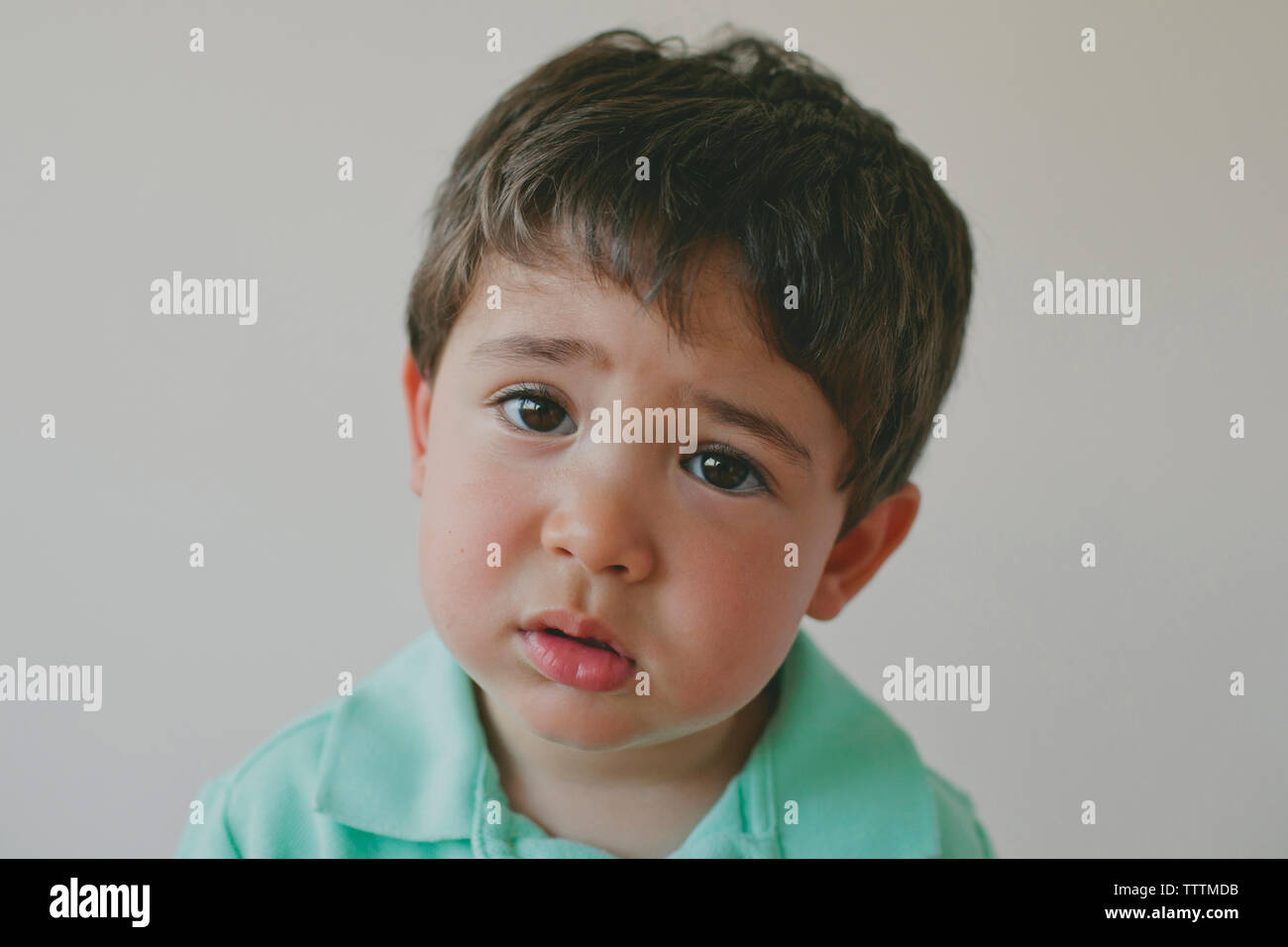 Close-up portrait of sad baby boy against gray background Stock Photo ...