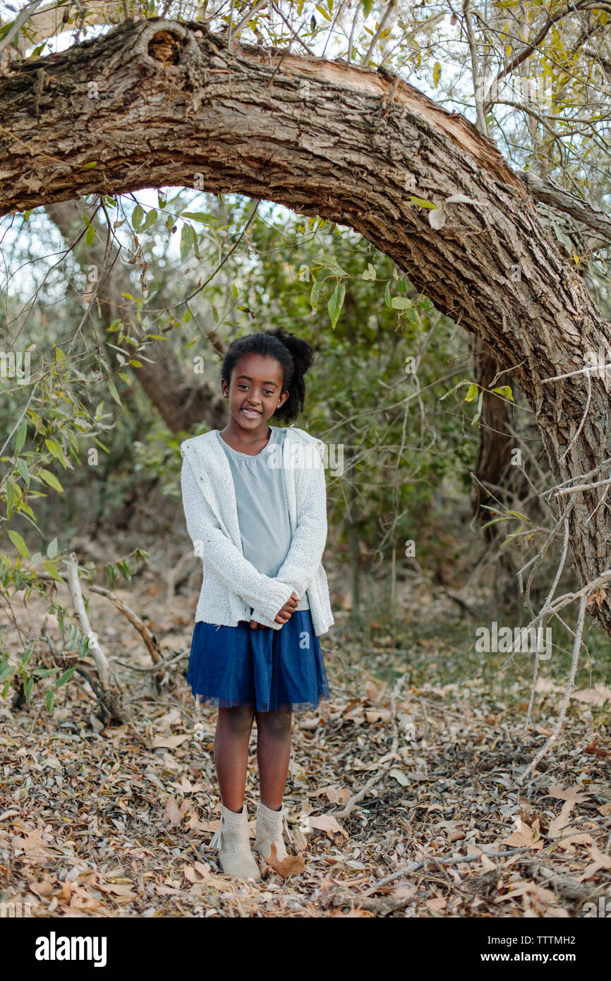 Full length portrait of girl standing on field at park Stock Photo - Alamy