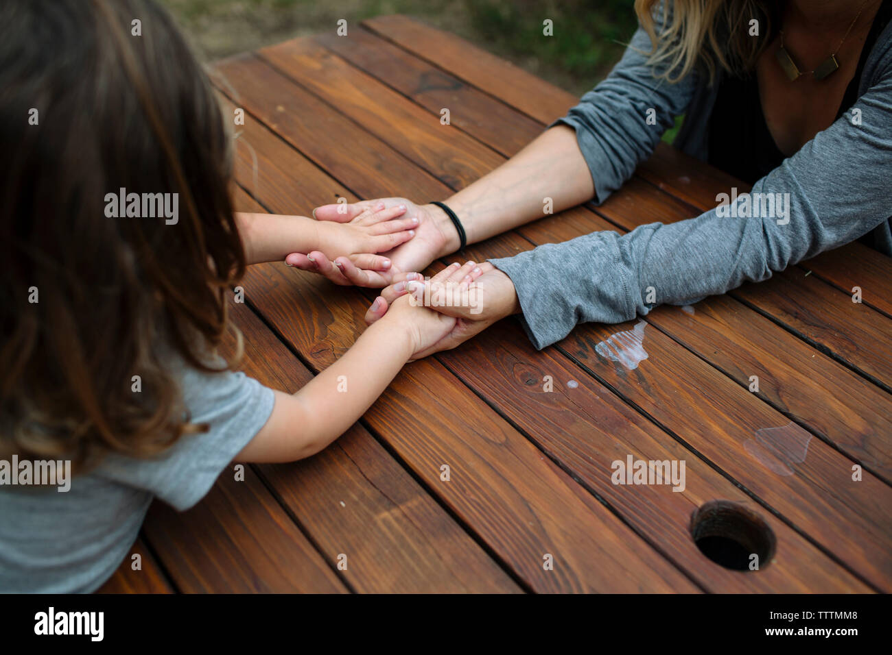 Family holding hands table hi-res stock photography and images - Alamy