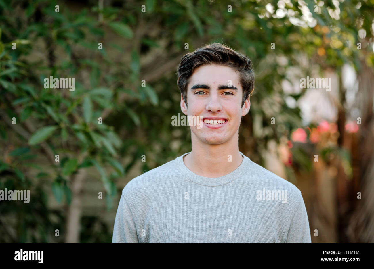 Standing and smiling hi-res stock photography and images - Alamy